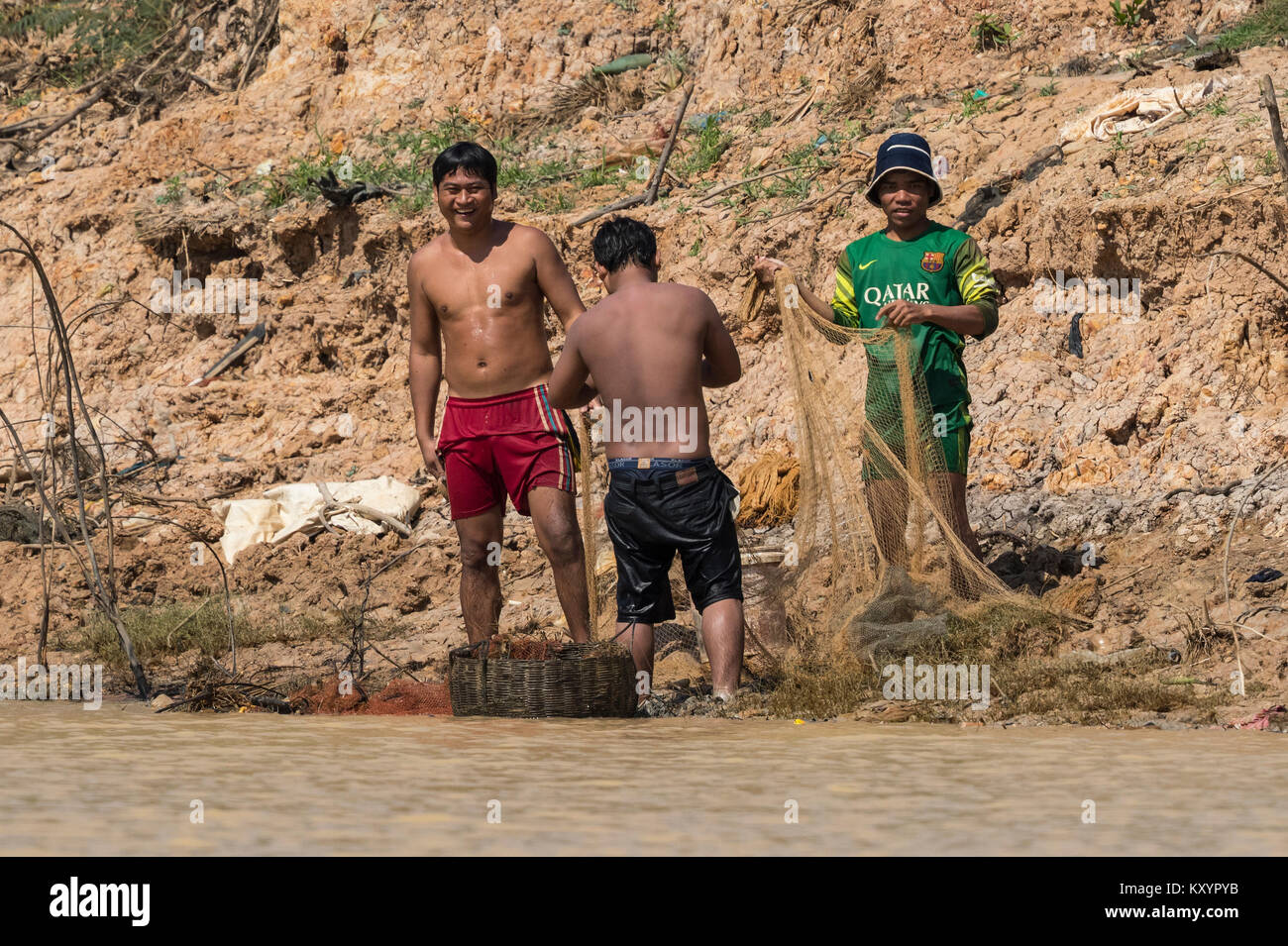 Three Fishermen smiling with the fishing net Prek Toal, Sangkae River ...