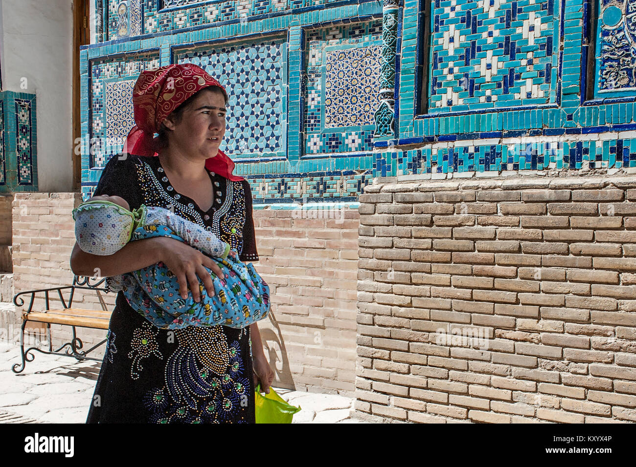 Uzbeki woman with baby in her arms Stock Photo - Alamy