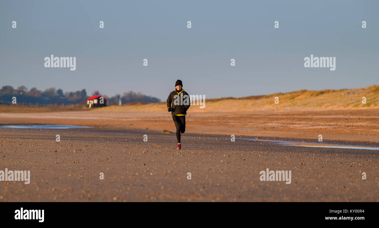 Female runner running on beach hi-res stock photography and images - Alamy