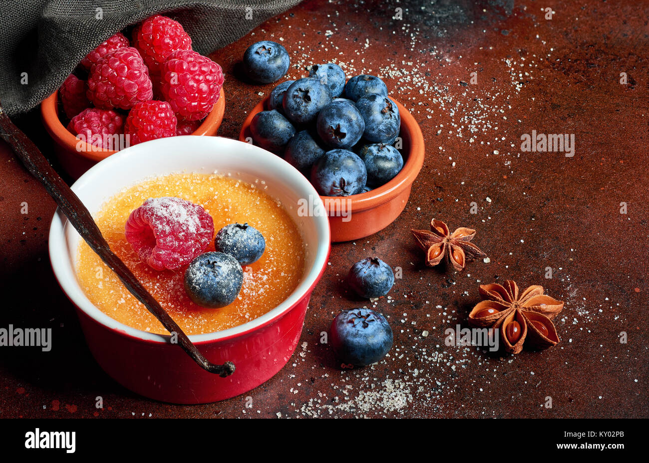 Creme brulee (cream brulee, burnt cream) with raspberry and blueberry ...