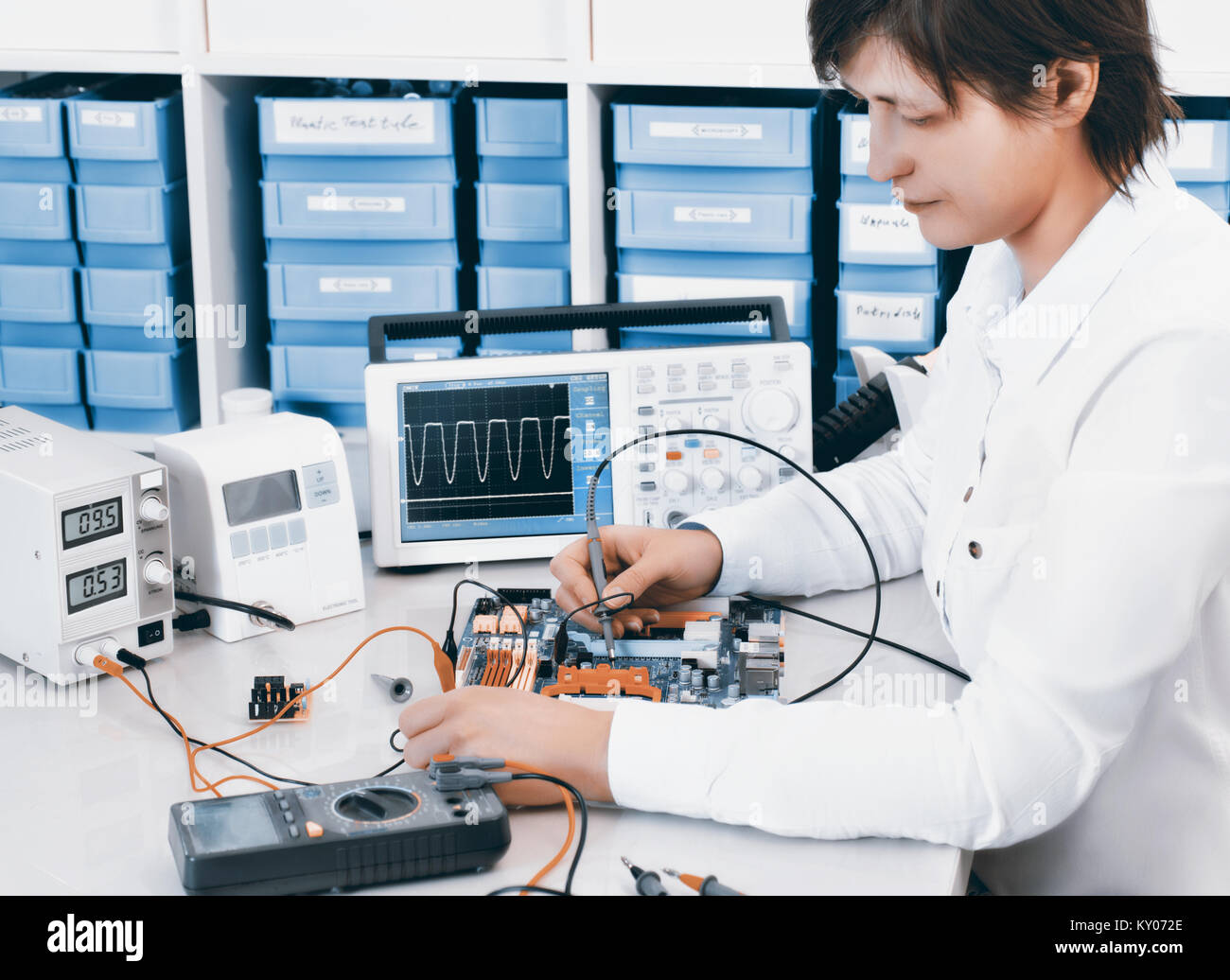 Tech tests electronic equipment in service center, toned image Stock ...