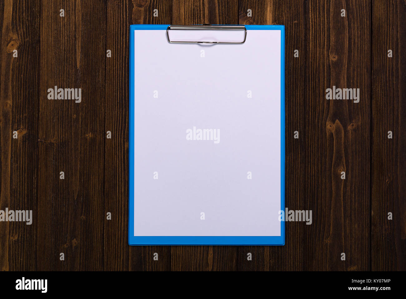 clipboard with blank white paper sheet on wood table top view with copy ...