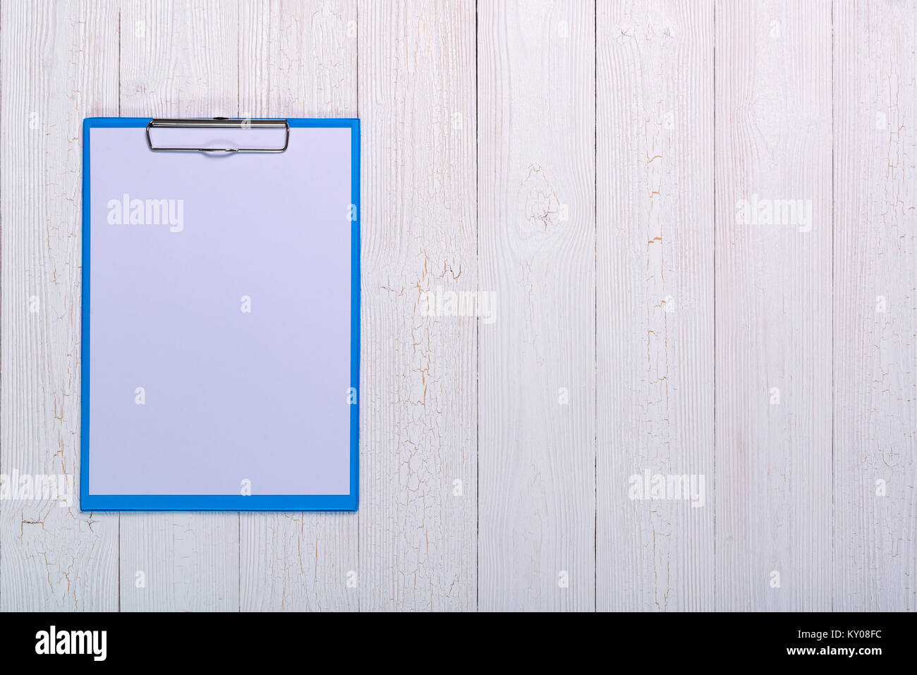 clipboard with blank white paper sheet on wood table top view with copy ...