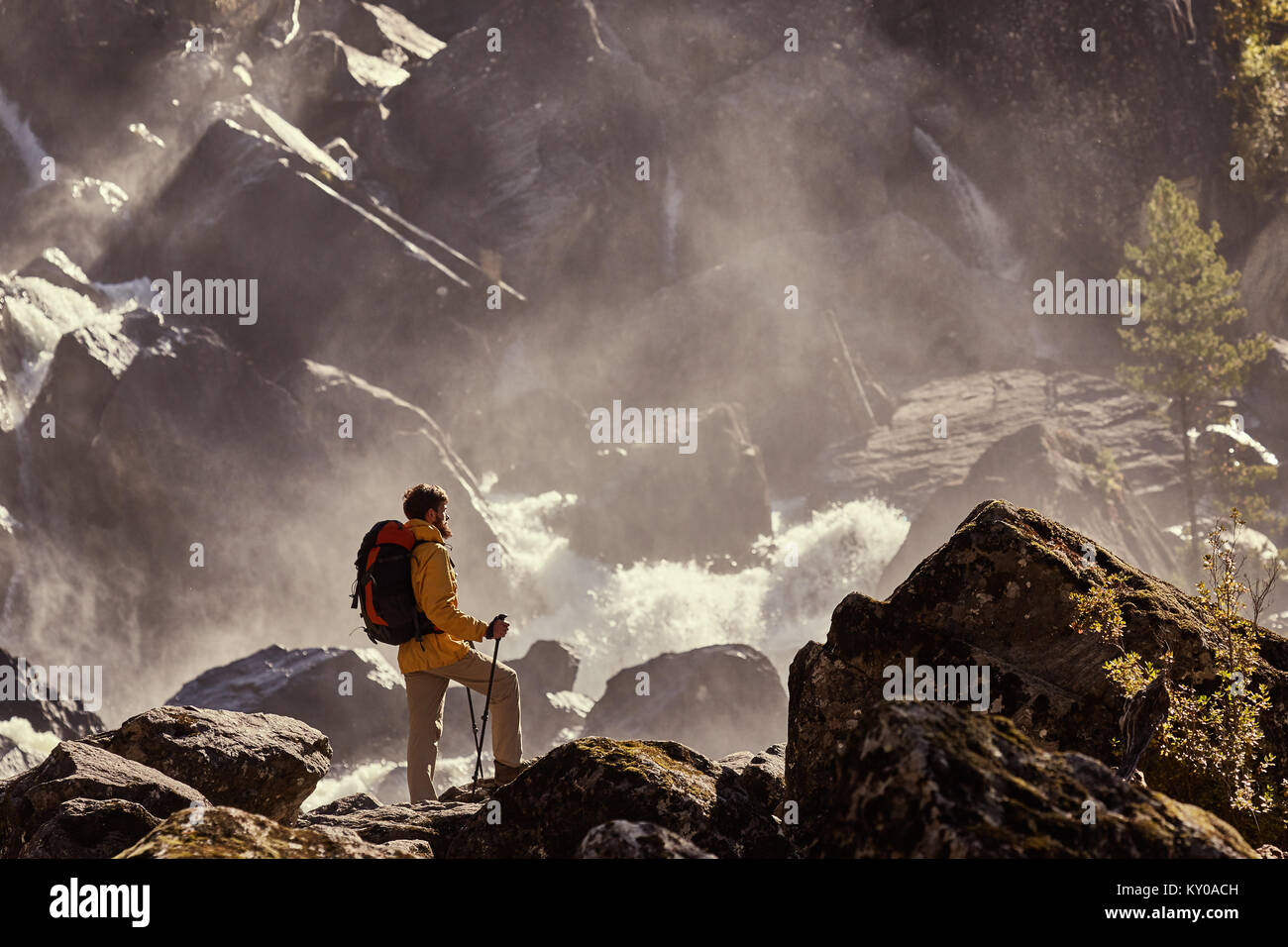 Hiker hiking with backpack looking at waterfall in park in beautiful ...