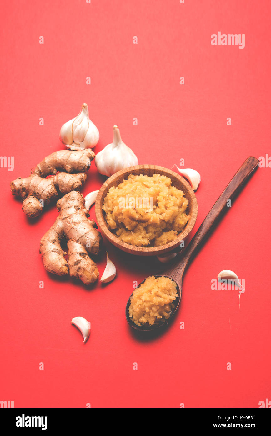 Fresh mashed Ginger puree / Adrak paste in white bowl with raw whole ...