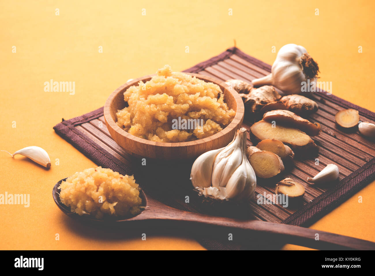 Fresh mashed Ginger puree / Adrak paste in white bowl with raw whole ...