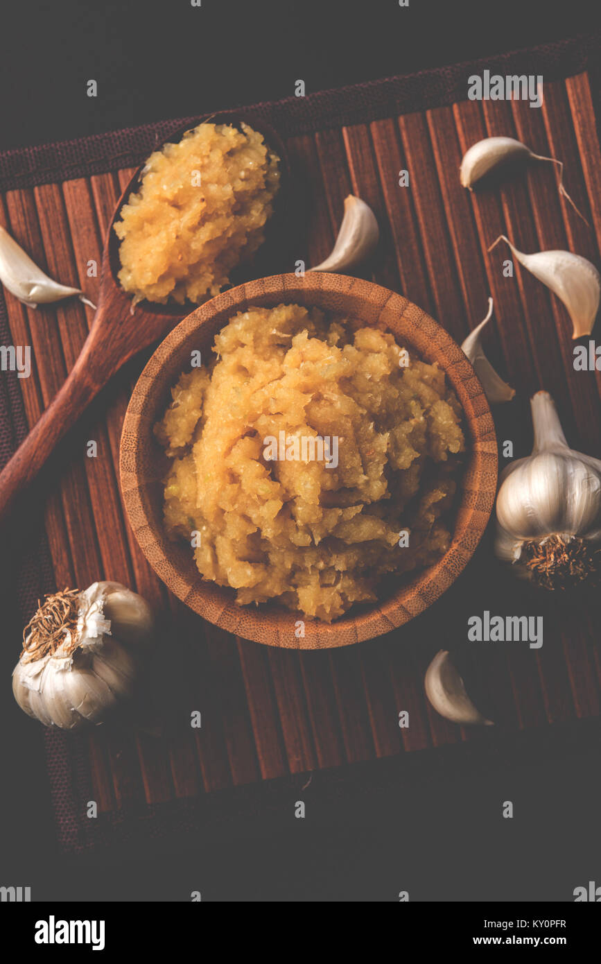 Fresh mashed Ginger puree / Adrak paste in white bowl with raw whole ...