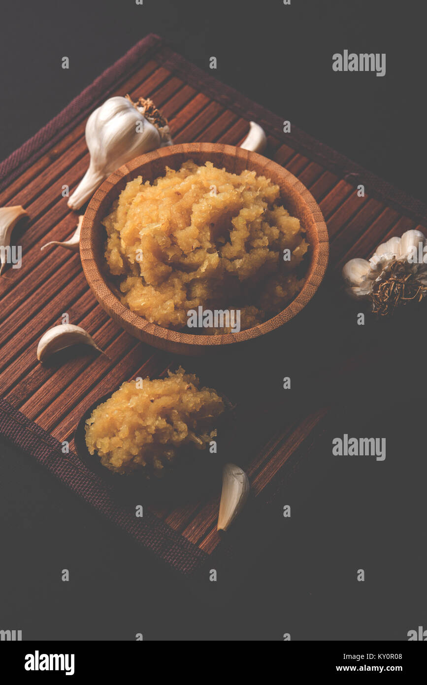 Fresh mashed Ginger puree / Adrak paste in white bowl with raw whole ...