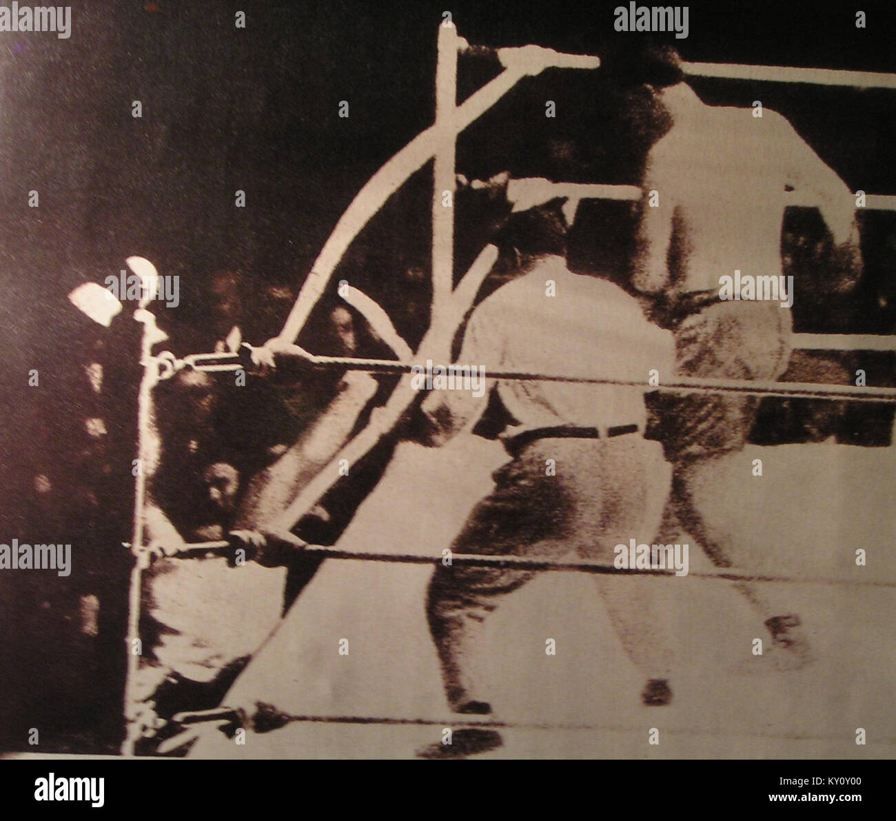 The image depicts boxer Luis Firpo knocking out Jack Dempsey, capturing ...