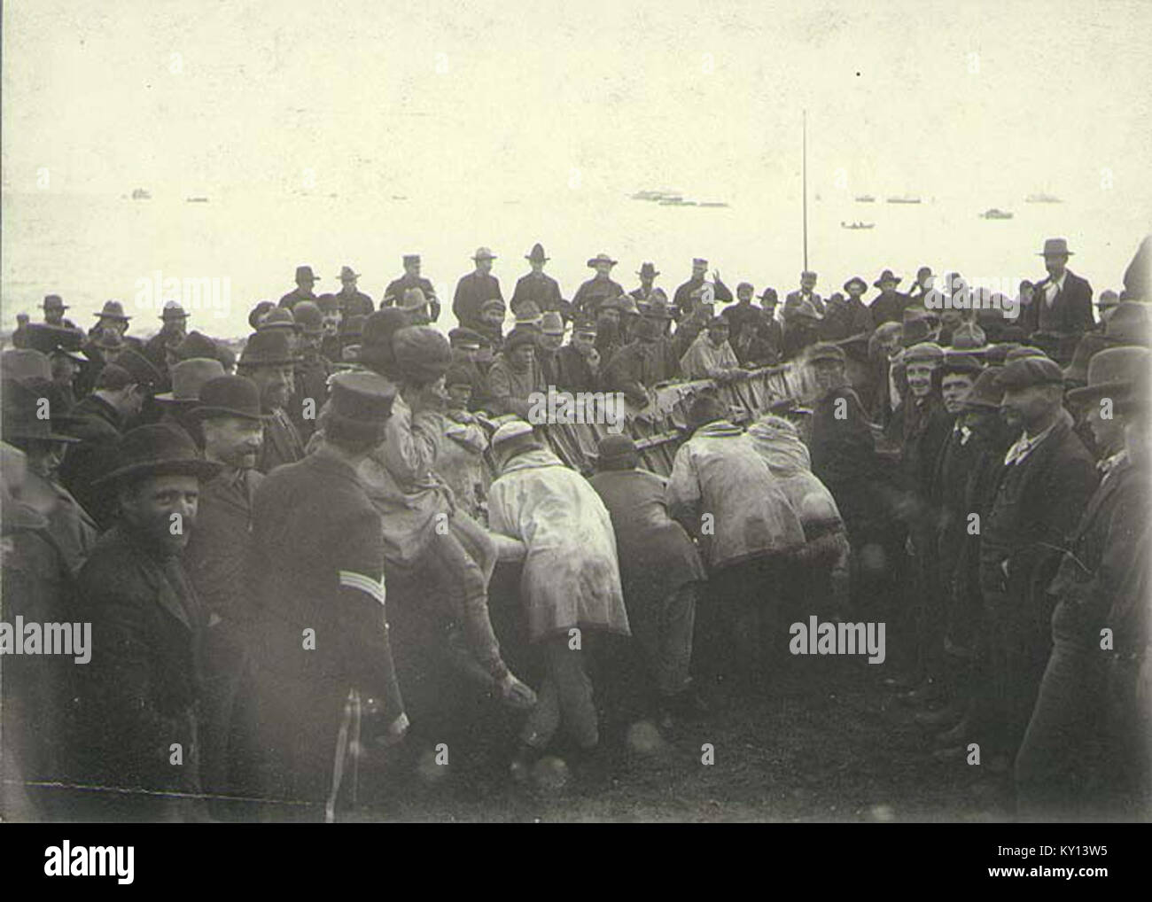 This photograph depicts Eskimo men with a umiak, a traditional skin ...