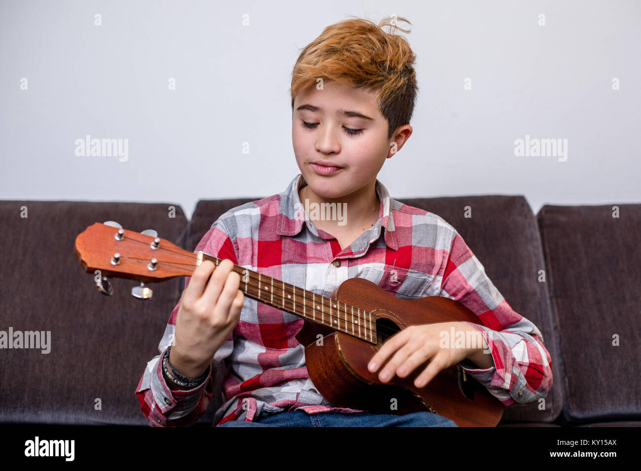 ELEVEN YEAR OLD CAUCASIAN BOY WITH TOP OF HEAD DYED ORANGE, WEARING ...