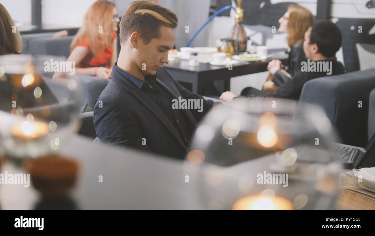 Man sitting in cafe with coffee Stock Photo - Alamy