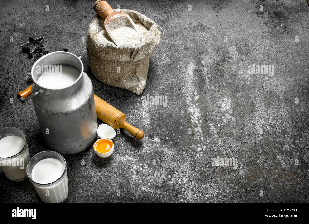 Baking background. Milk, flour and other ingredients for the dough. On ...