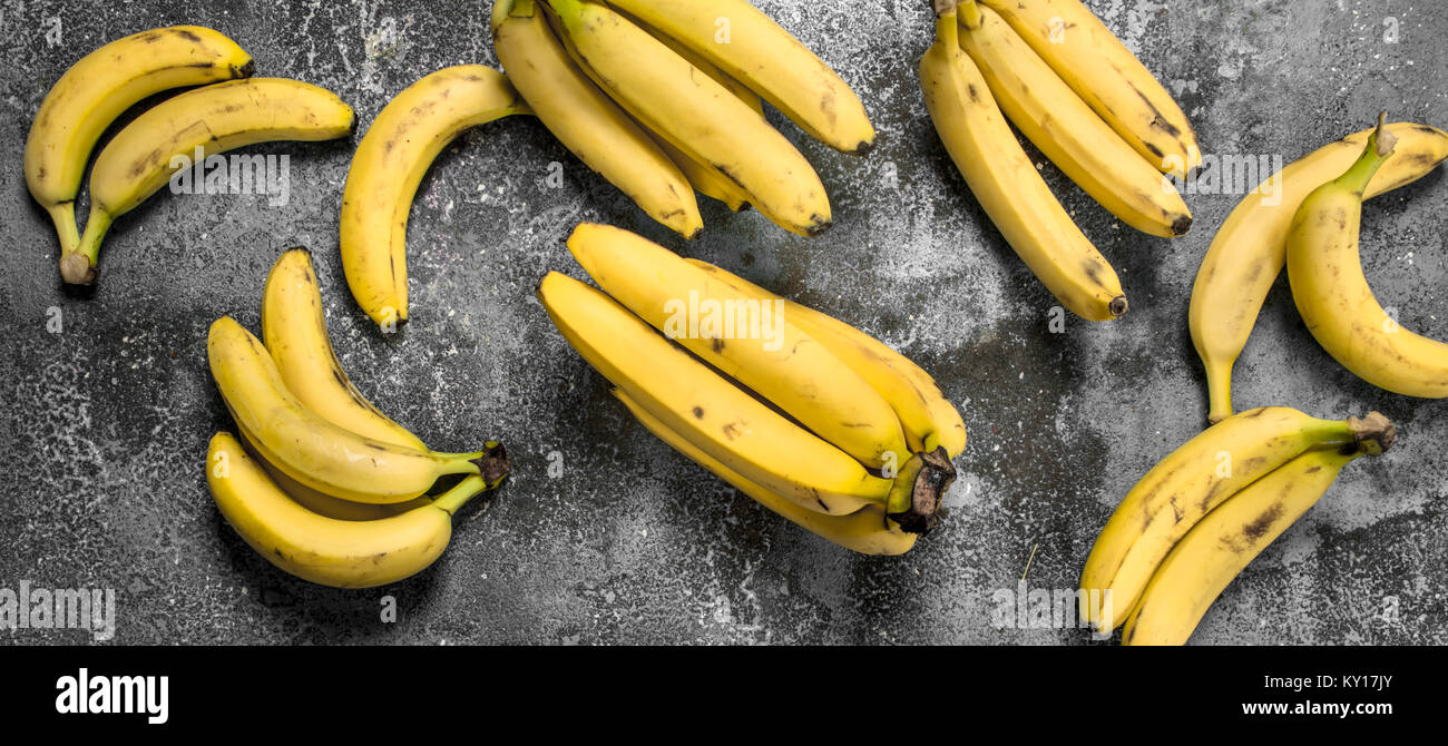 Fresh bunches of bananas. On a rustic background Stock Photo - Alamy