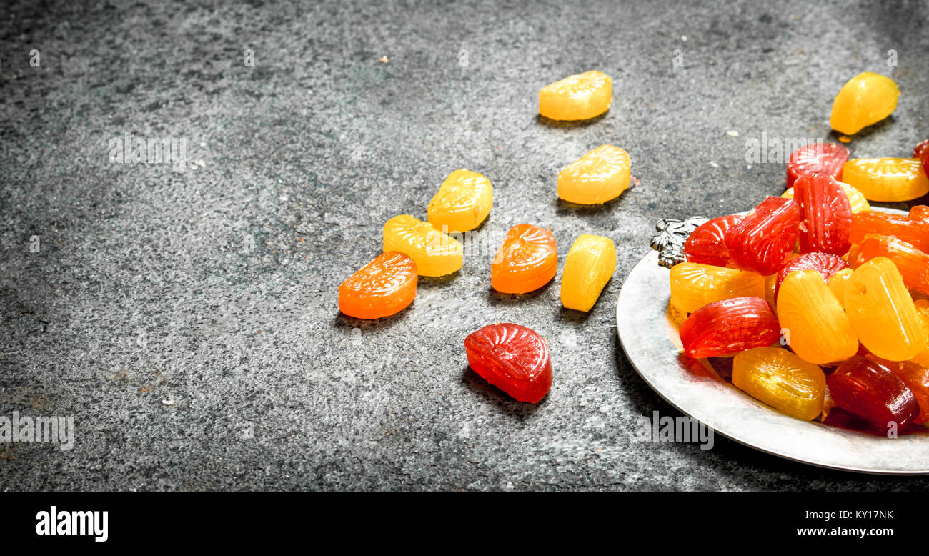 Fruit candies on a steel tray. On a rustic background Stock Photo - Alamy