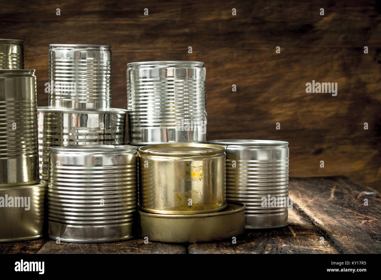 Food in tin cans. On a wooden background Stock Photo - Alamy
