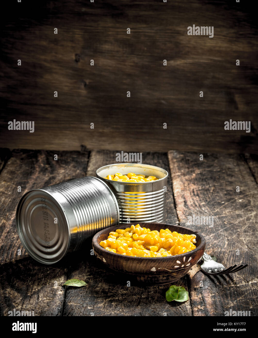 Canned corn in a tin can with fork. On a wooden background Stock Photo ...