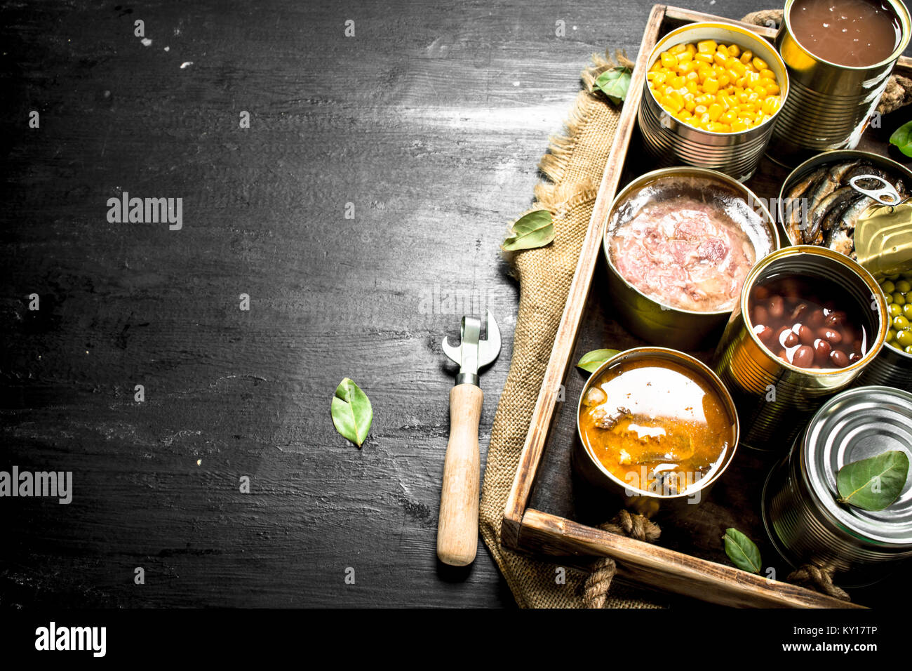 Various canned fruits, vegetables, fish and meat in tin cans on old ...