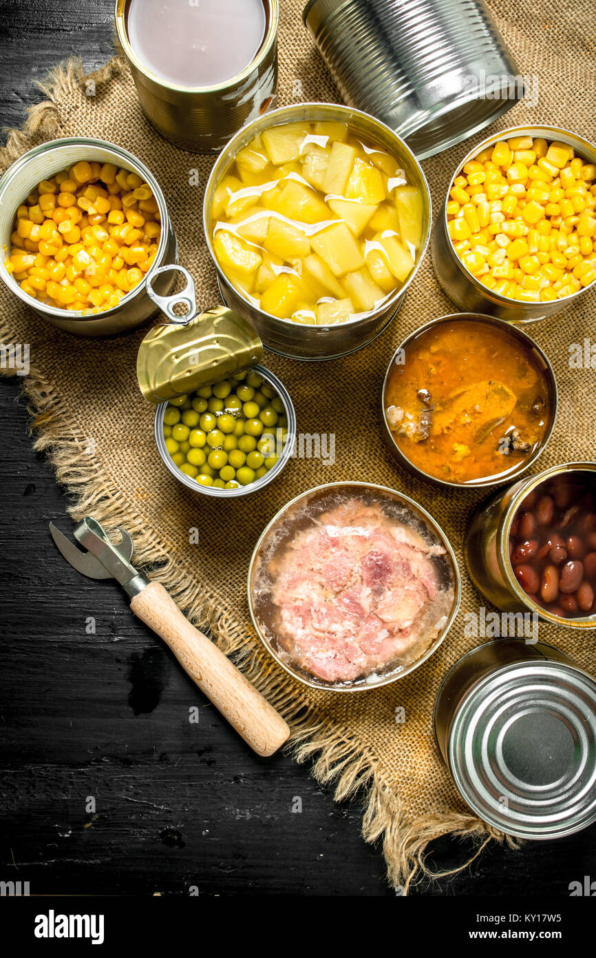 Different canned products in tin cans. On the black chalkboard Stock ...