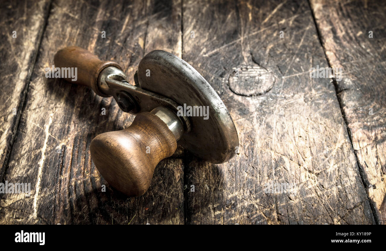 Old canning seamer. On a wooden background Stock Photo - Alamy