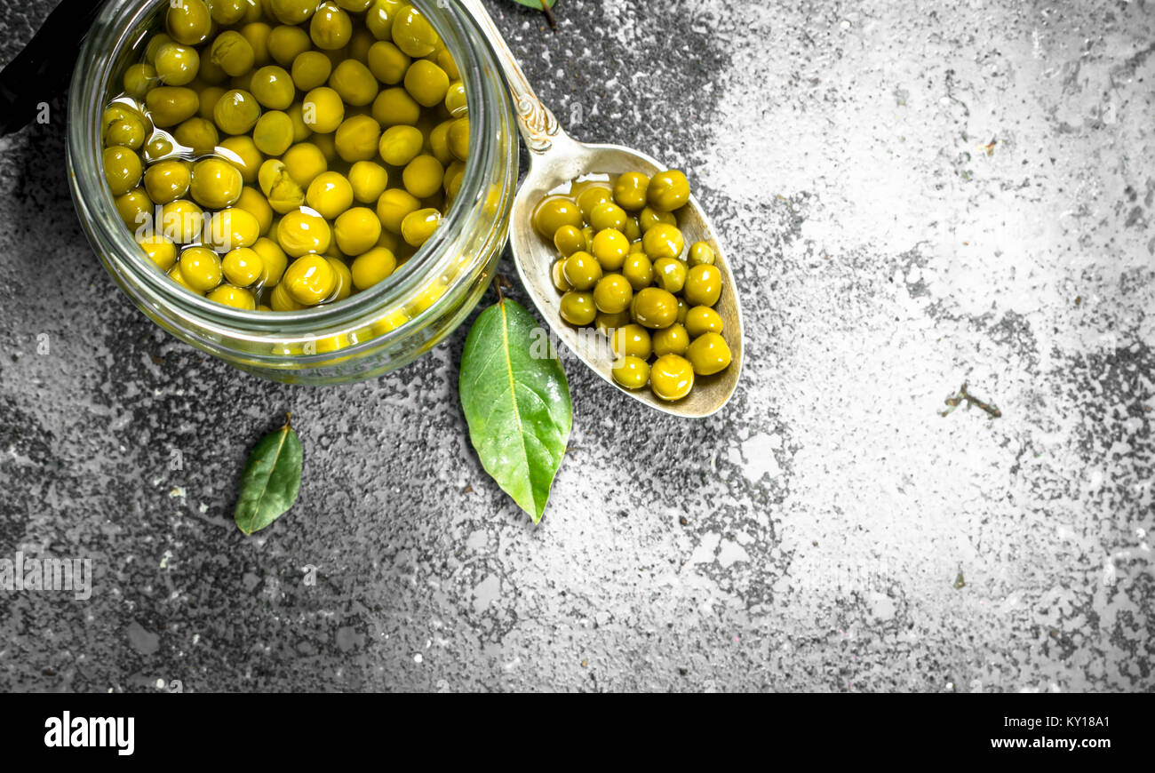 Marinated green peas in glass jar. On a rustic background Stock Photo ...