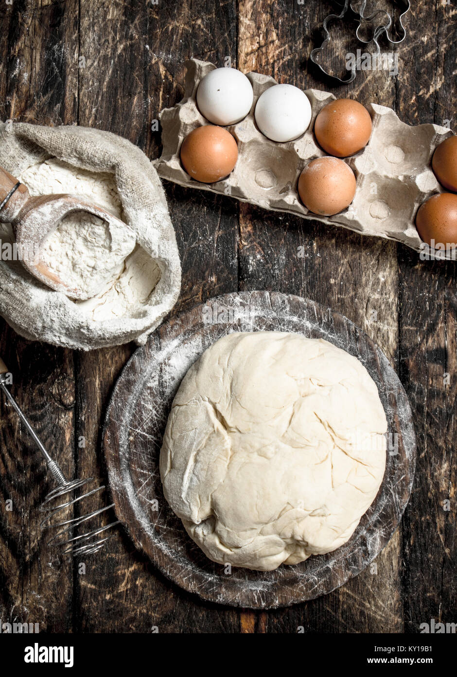 Fresh dough with ingredients. On a wooden background Stock Photo - Alamy