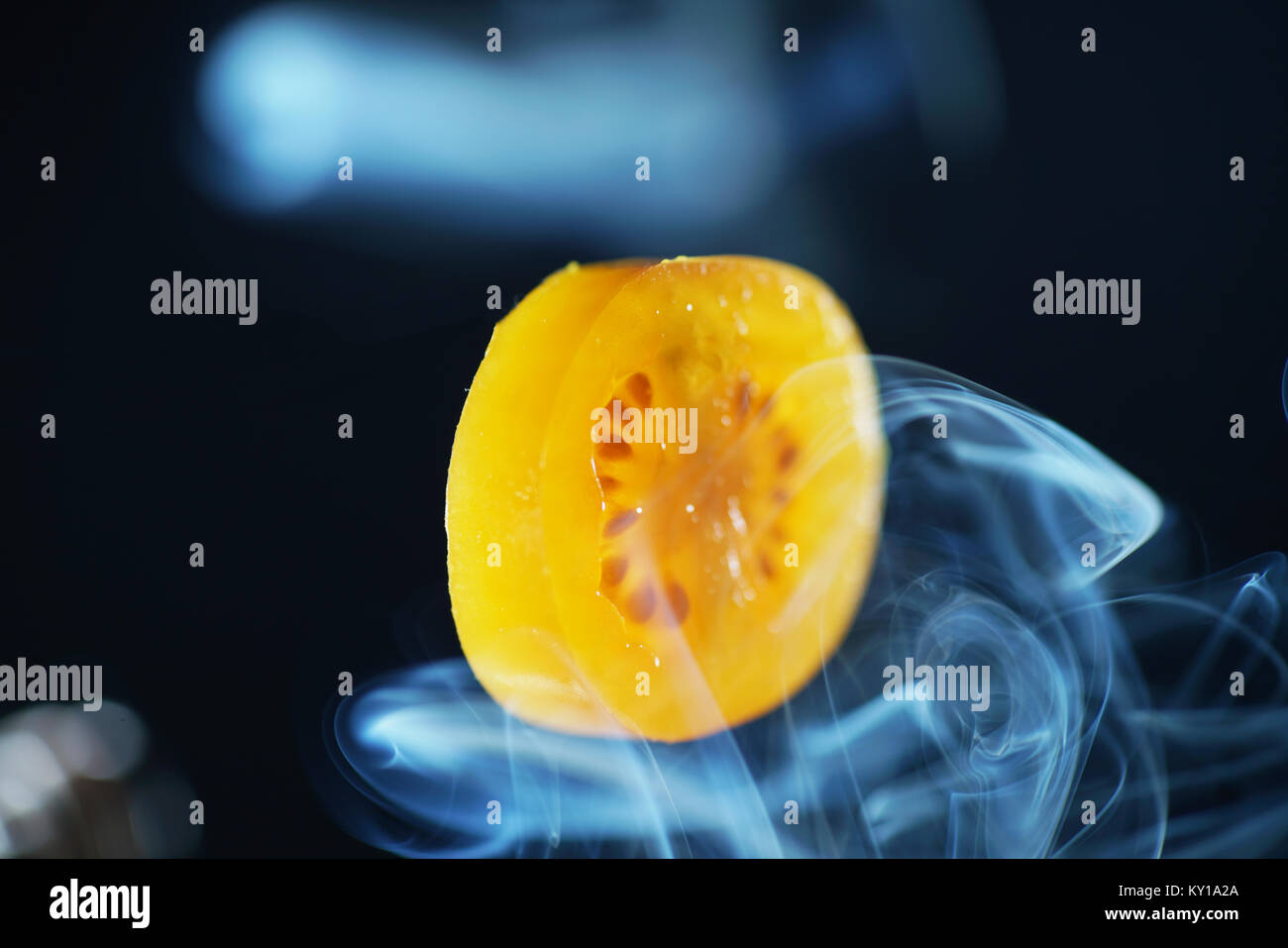 A tomato sliced and photographed in front of flash in the studio Stock ...
