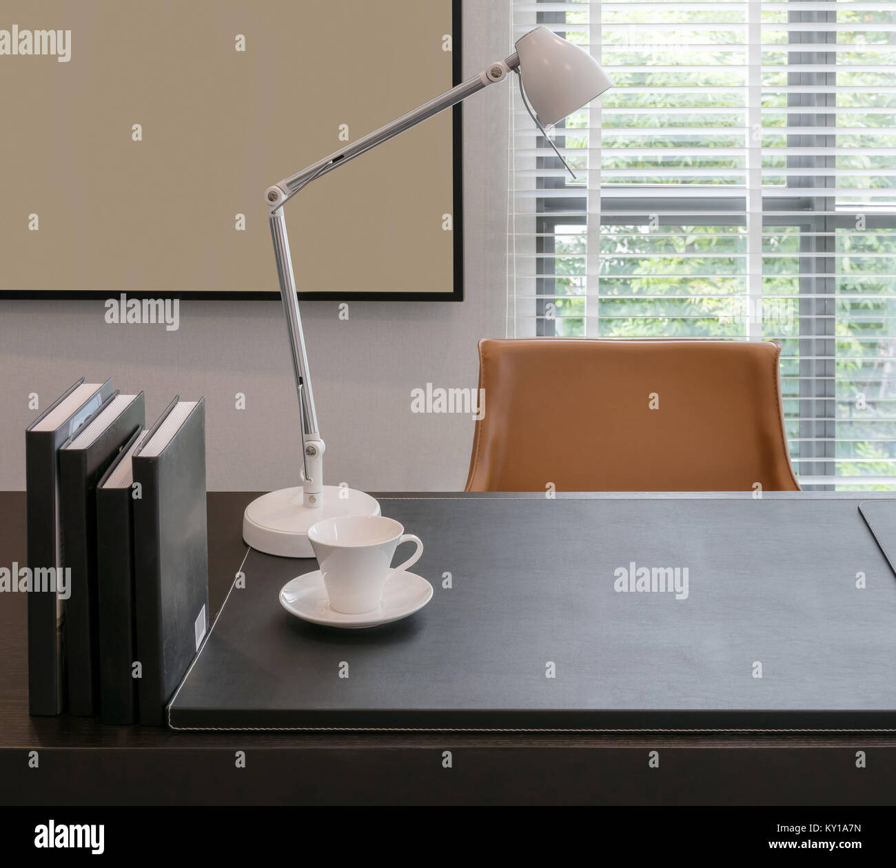 wooden table with lamp and books in modern working room interior Stock ...