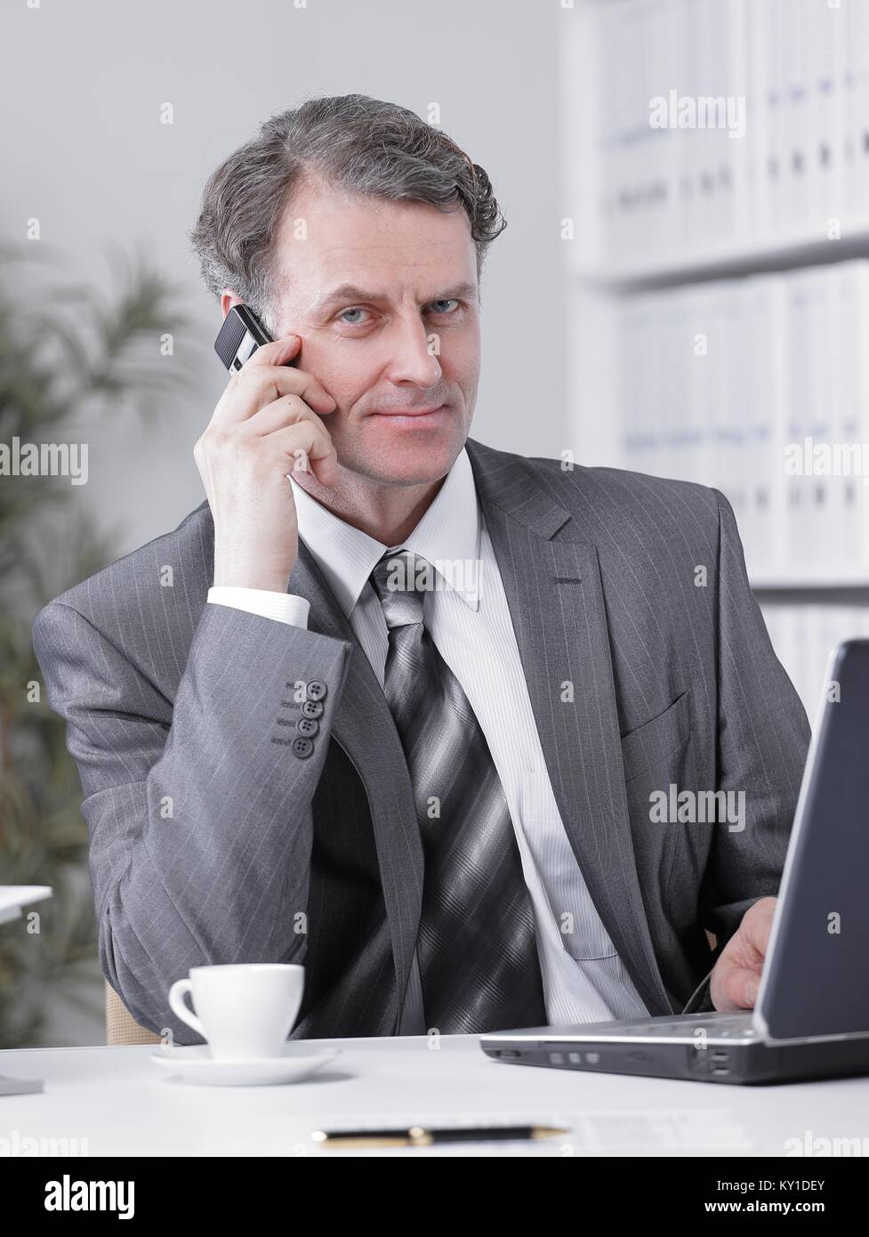 Businessman having phone call conversation at workplace Stock Photo - Alamy