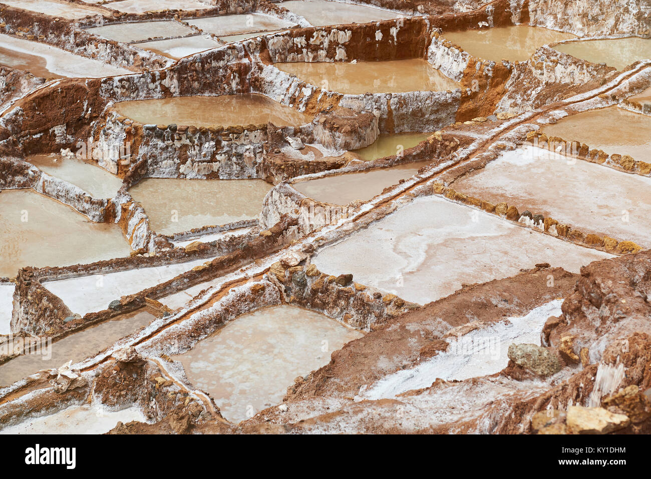 Traditional way of salt mining in Cusco Peru. Brown pools with salty ...