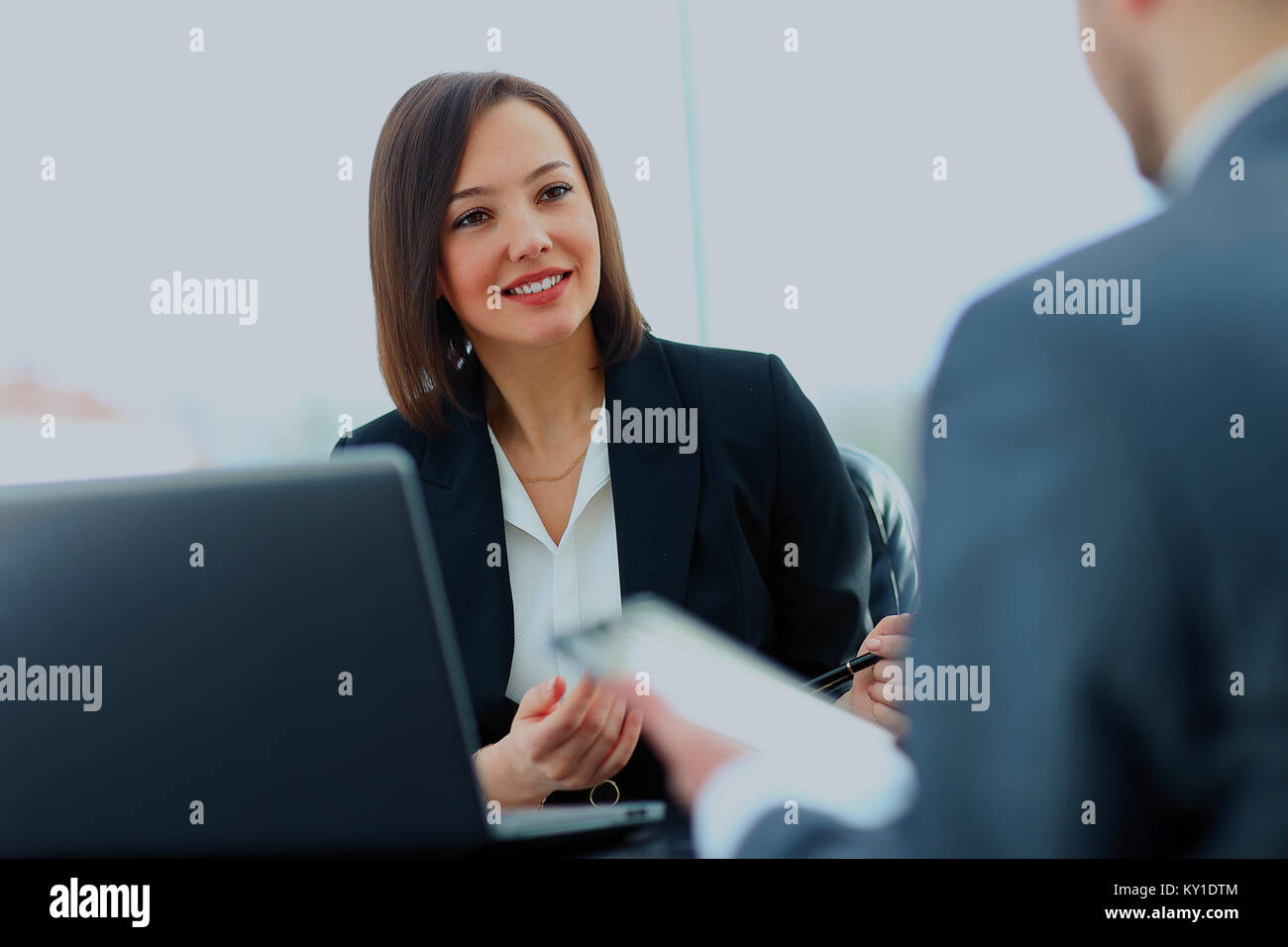 Beautiful young businesswoman conducting a job interview seated at her ...