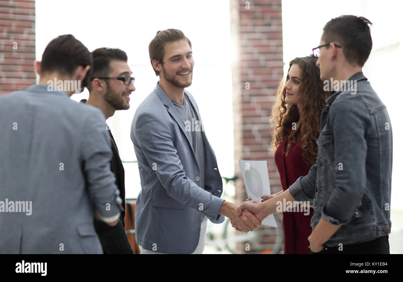 handshake partners in the creative office Stock Photo - Alamy