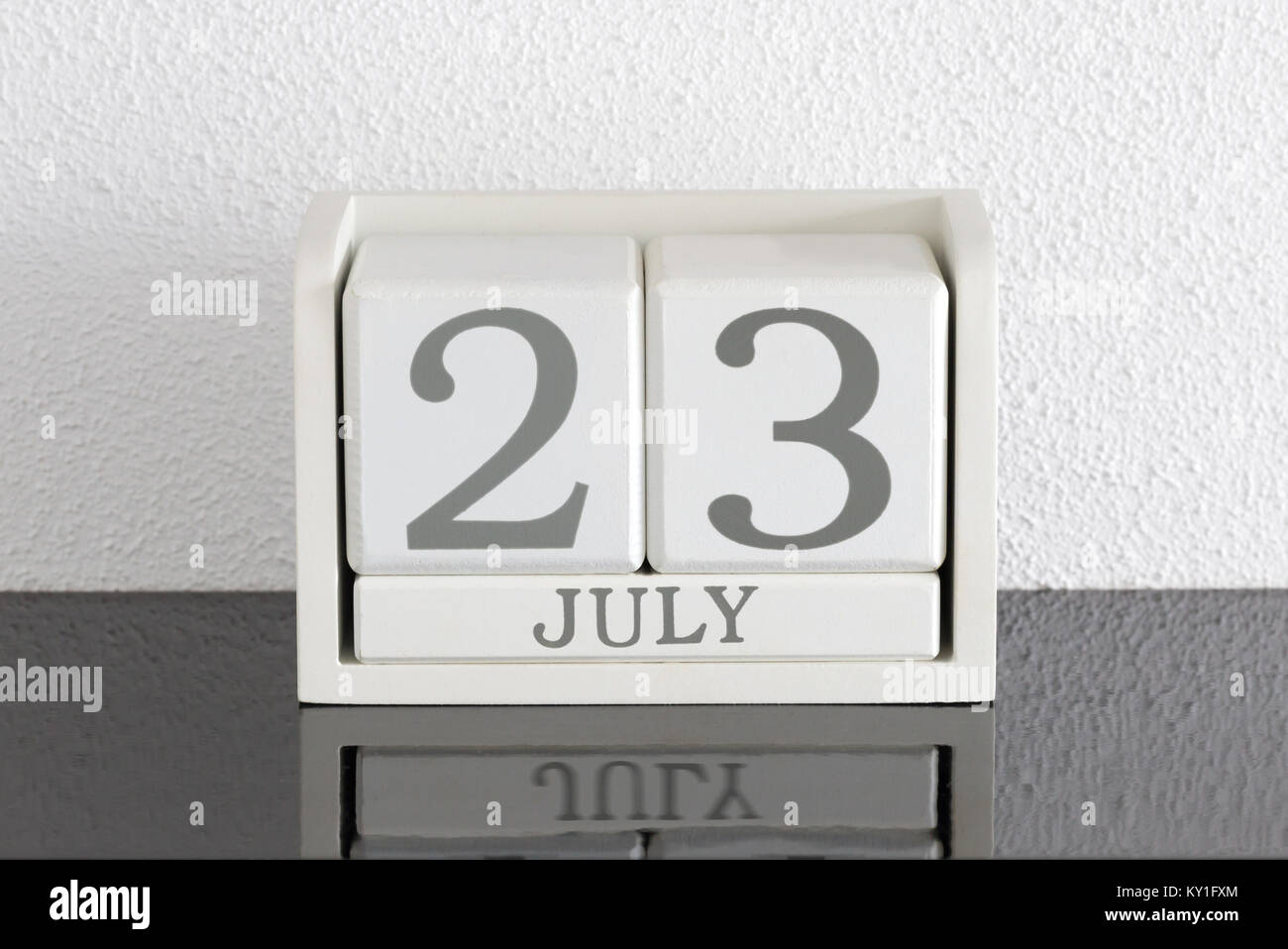 White block calendar present date 23 and month July on white wall ...