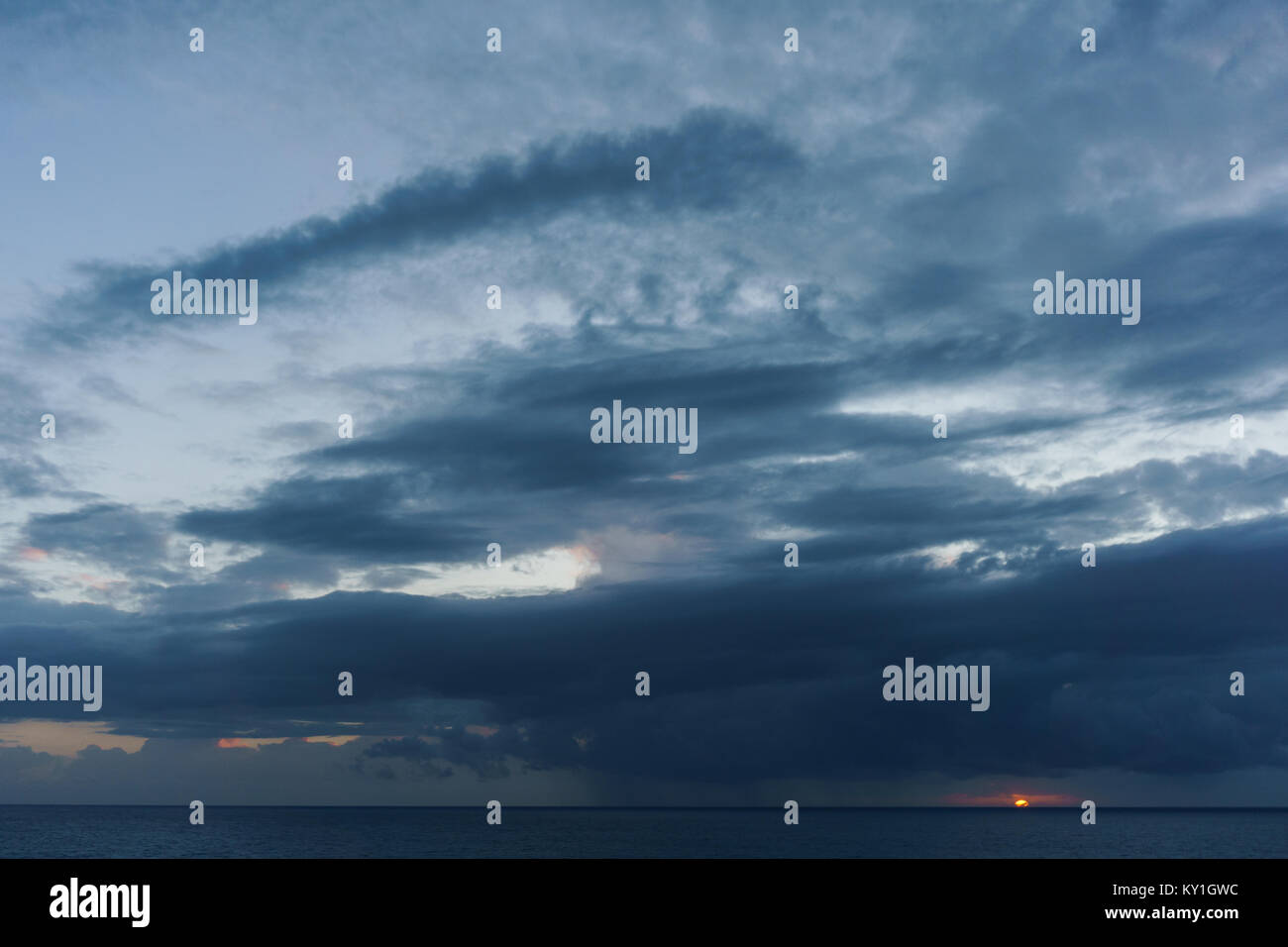Picture of sea, red sun, cloudy sky Stock Photo - Alamy