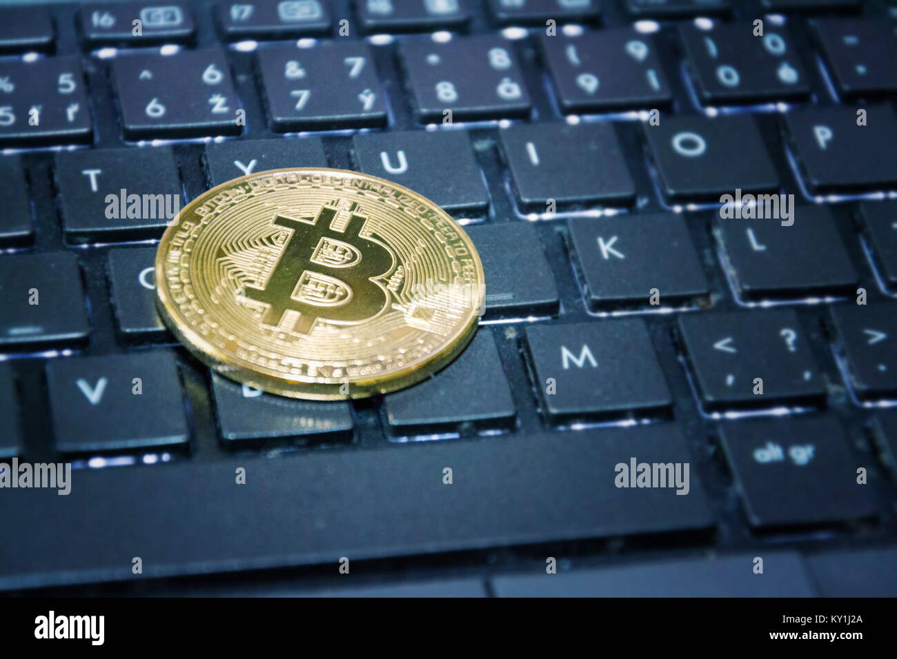 Golden bitcoin coin on computer keyboard, cryptocurrency bitcoin mining ...