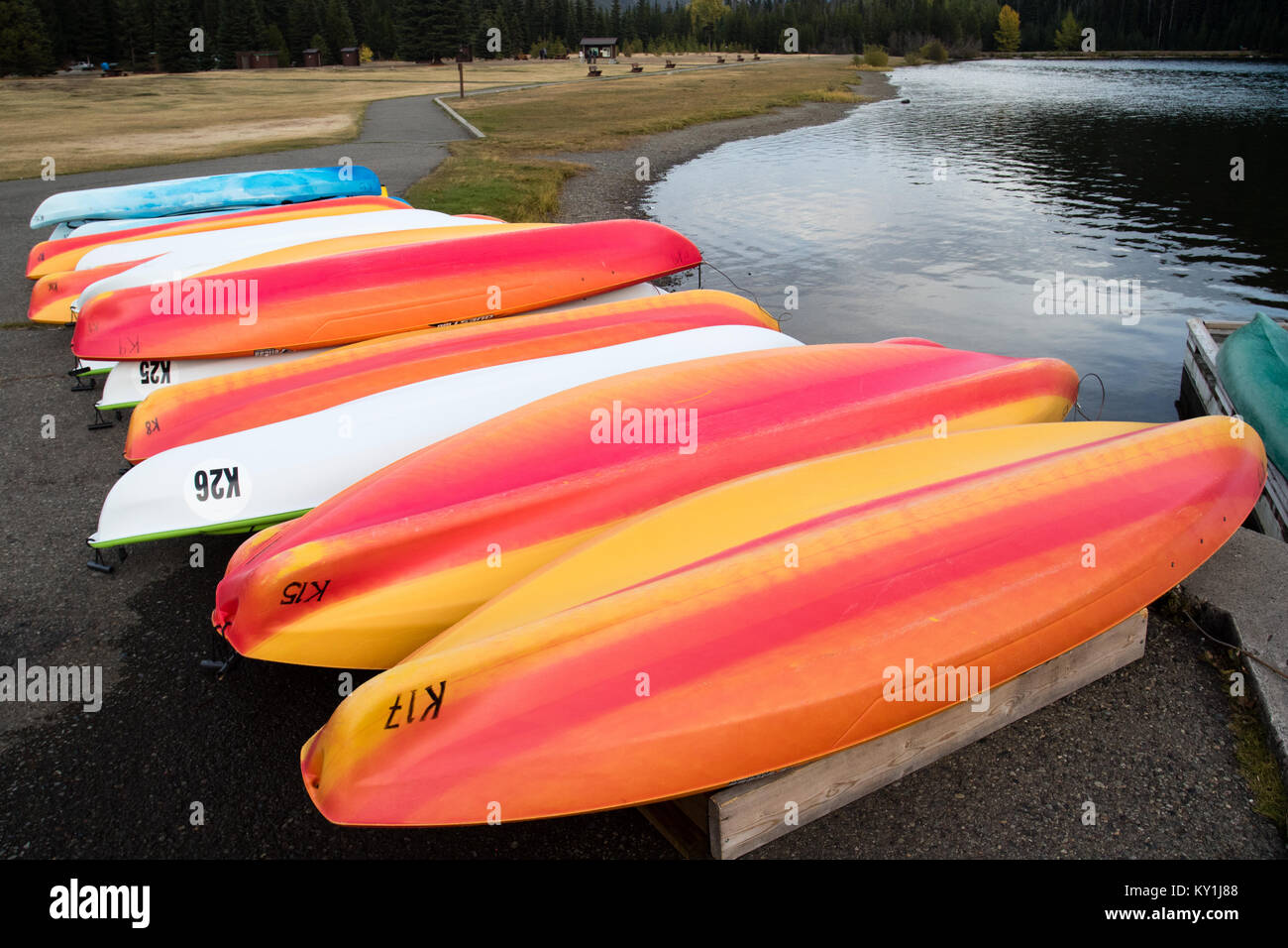 Colorful kayaks on a lake shore Stock Photo - Alamy