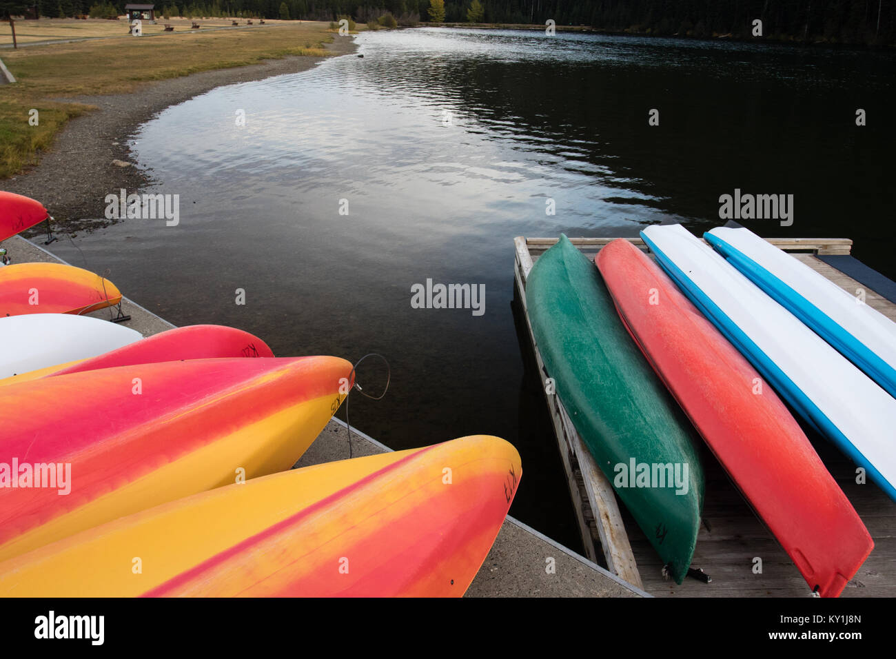 Colorful kayaks on a lake shore Stock Photo - Alamy
