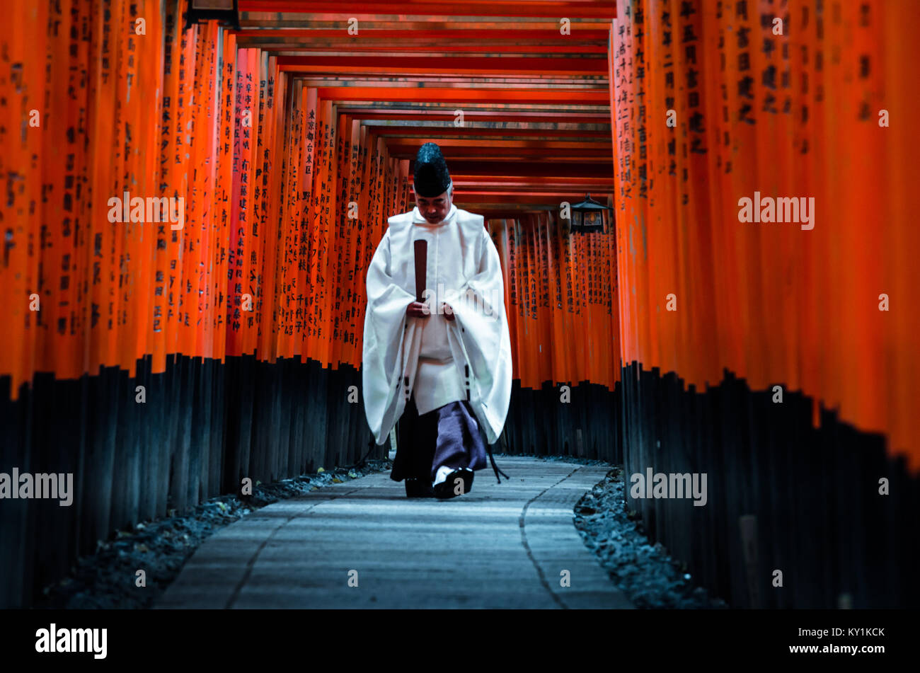 Japanese Priest walking up hill in Kyoto most famous shine, Fushima ...
