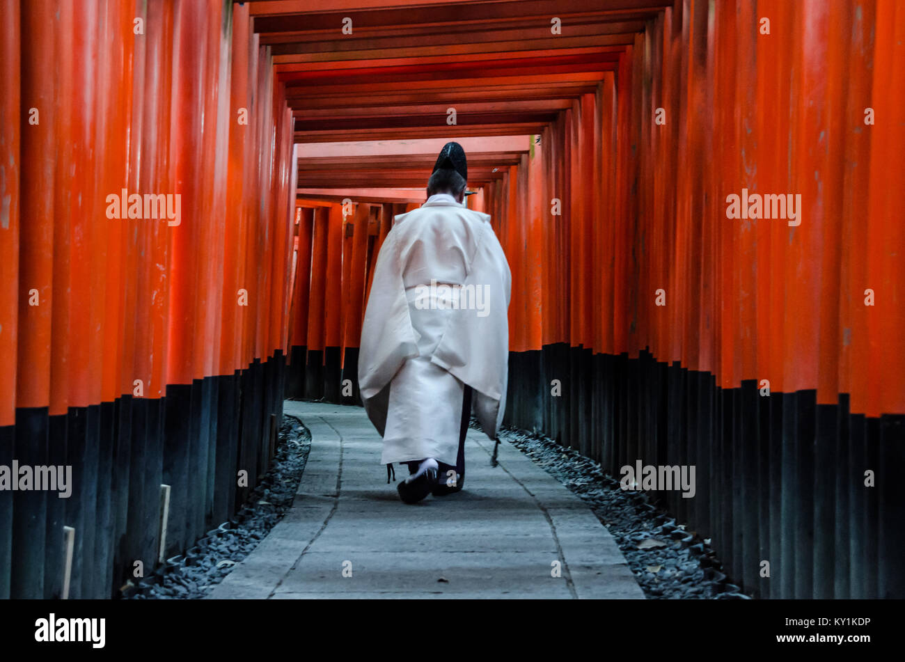 Japanese Priest walking up hill in Kyoto most famous shine, Fushima ...