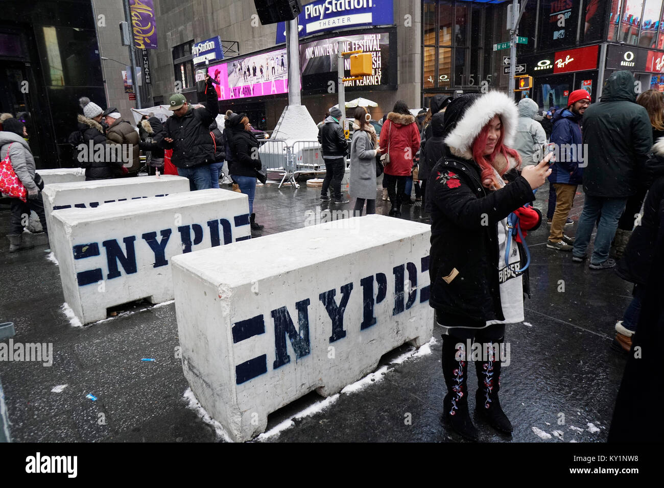 Tourists pass through barricades at the perimeter of Times Square in ...