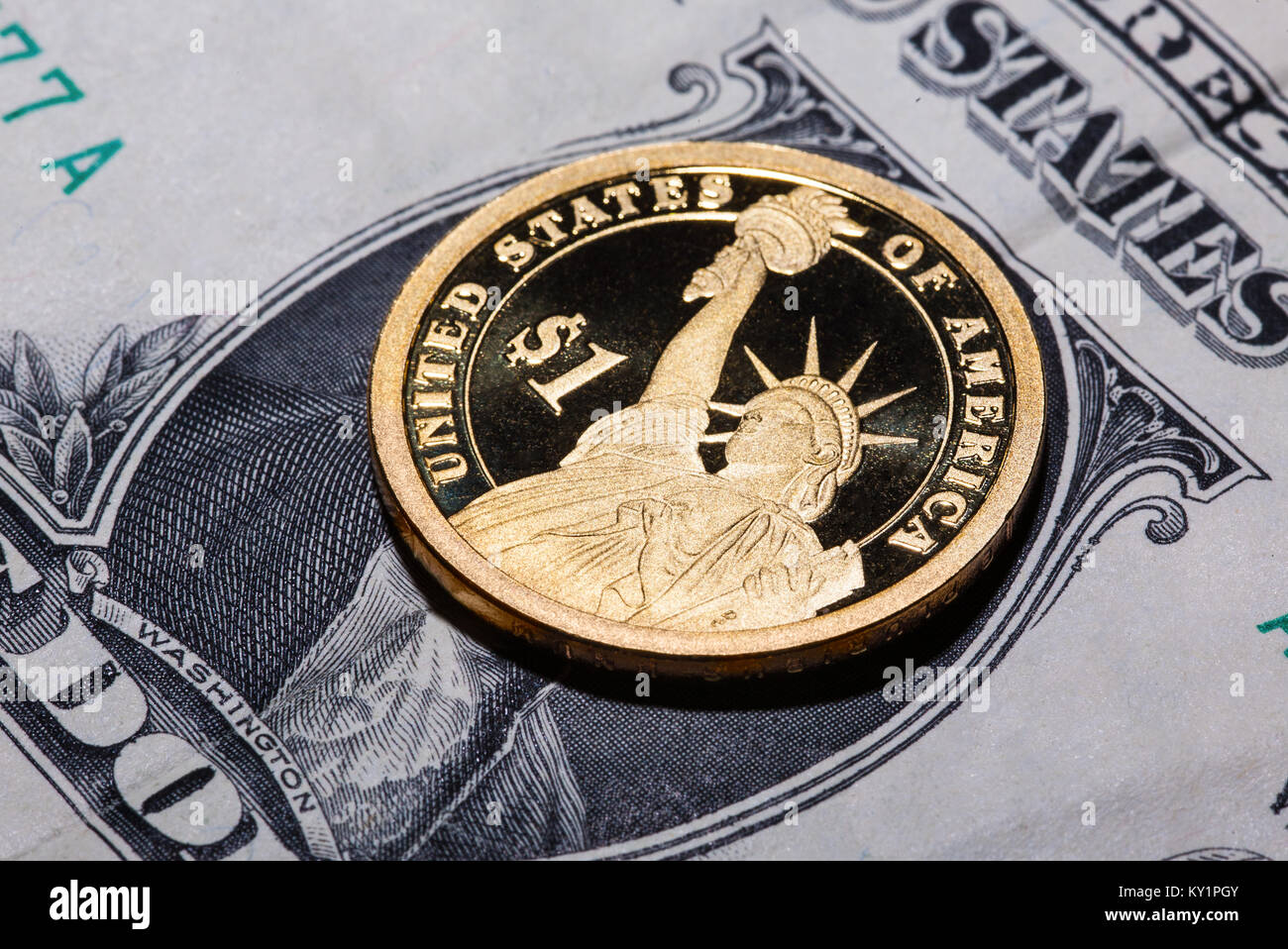 One dollar coin - The Statue of Liberty - on one dollar banknote Stock ...