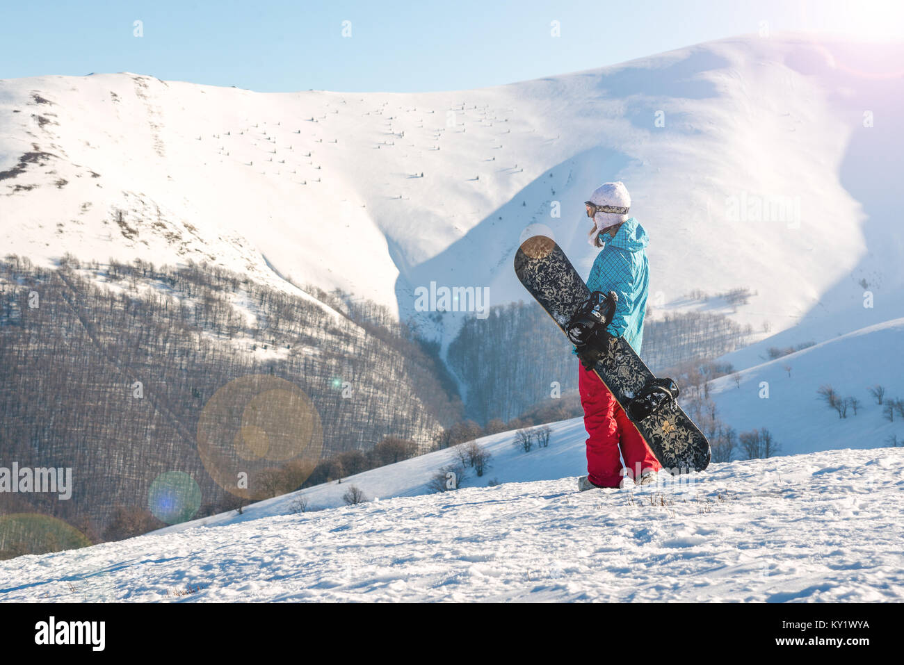 snowboarder girl standing with snowboard Stock Photo - Alamy