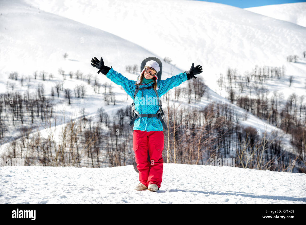 snowboarder girl standing with snowboard Stock Photo - Alamy