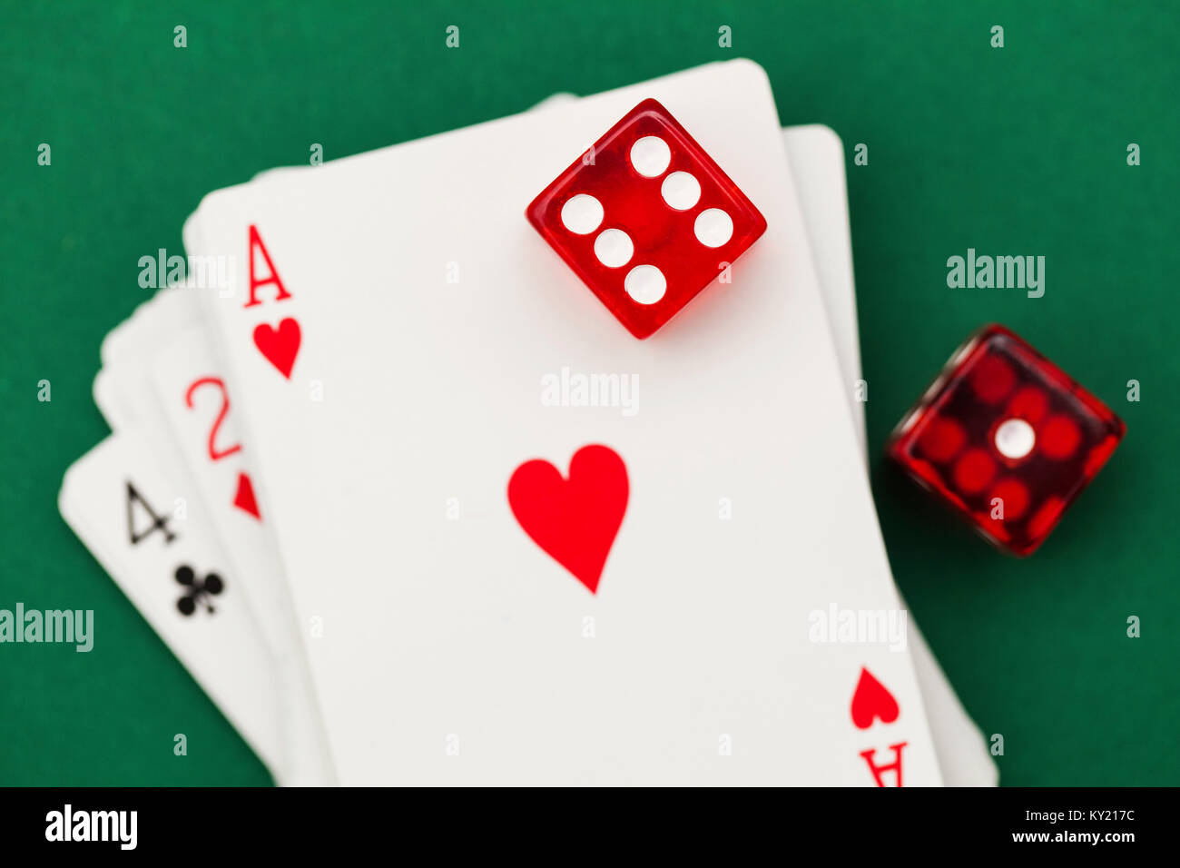 Poker cards and dice on a green background Stock Photo - Alamy