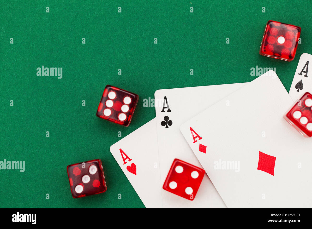 Poker cards and dice on a green background Stock Photo - Alamy