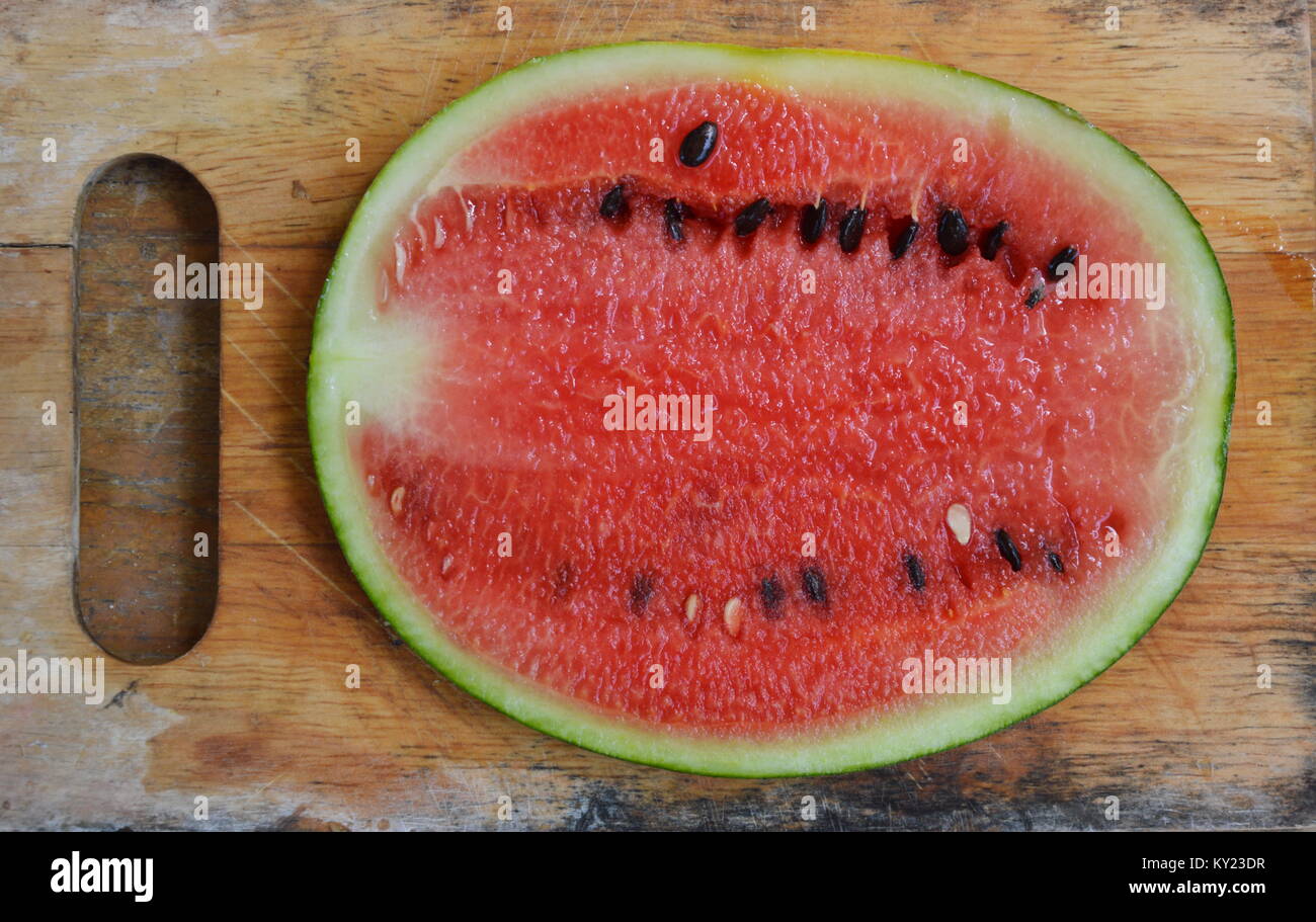 watermelon slice on wooden chop block Stock Photo - Alamy