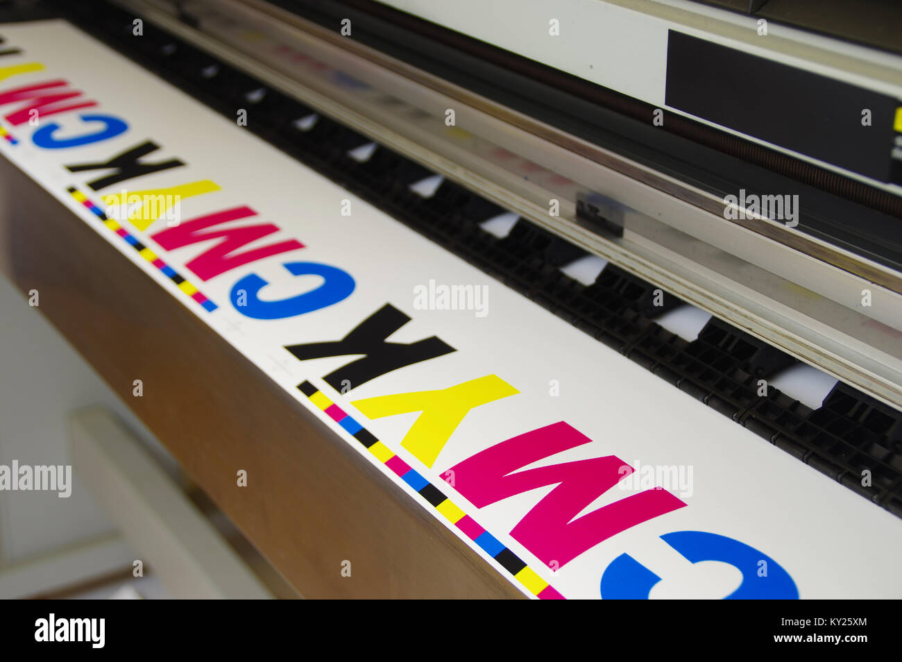 Digital large inkjet machine. Plotter printed CMYK test on white paper ...