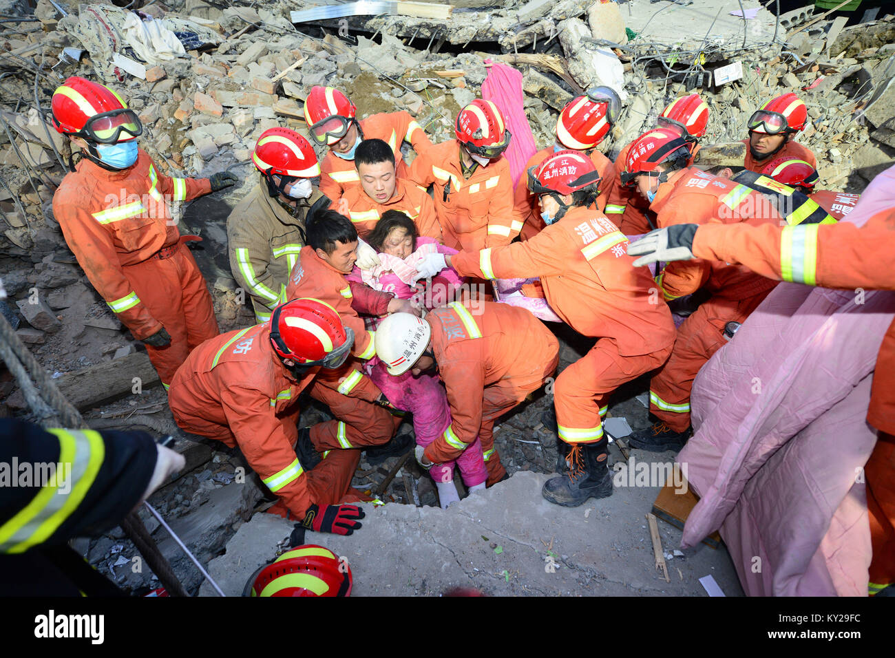 Beijing, China. 12th Jan, 2018. Rescuers pull out a survivor from ...