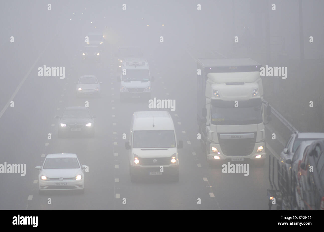 Vehicles travel through morning fog on the M1 Motorway, Wakefield, UK ...