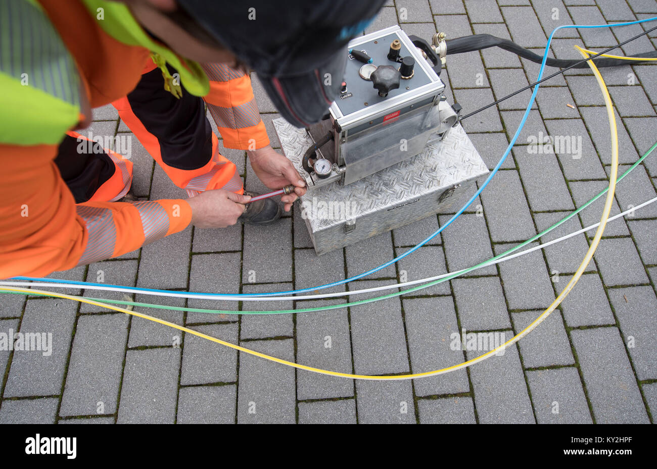 A specialist for the installation of optical fibre demonstrates how a ...